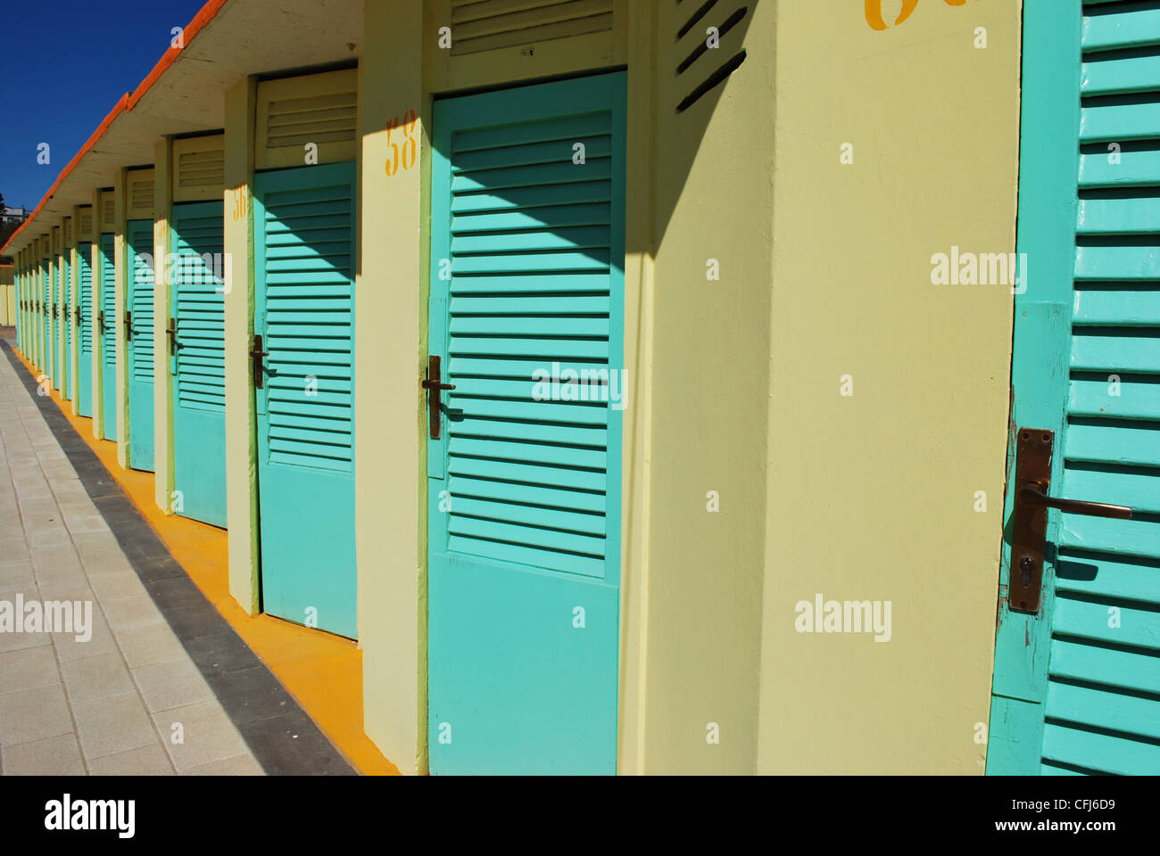 Perspective row of turquoise and yellow beach huts, Rimini, Italy Stock ...