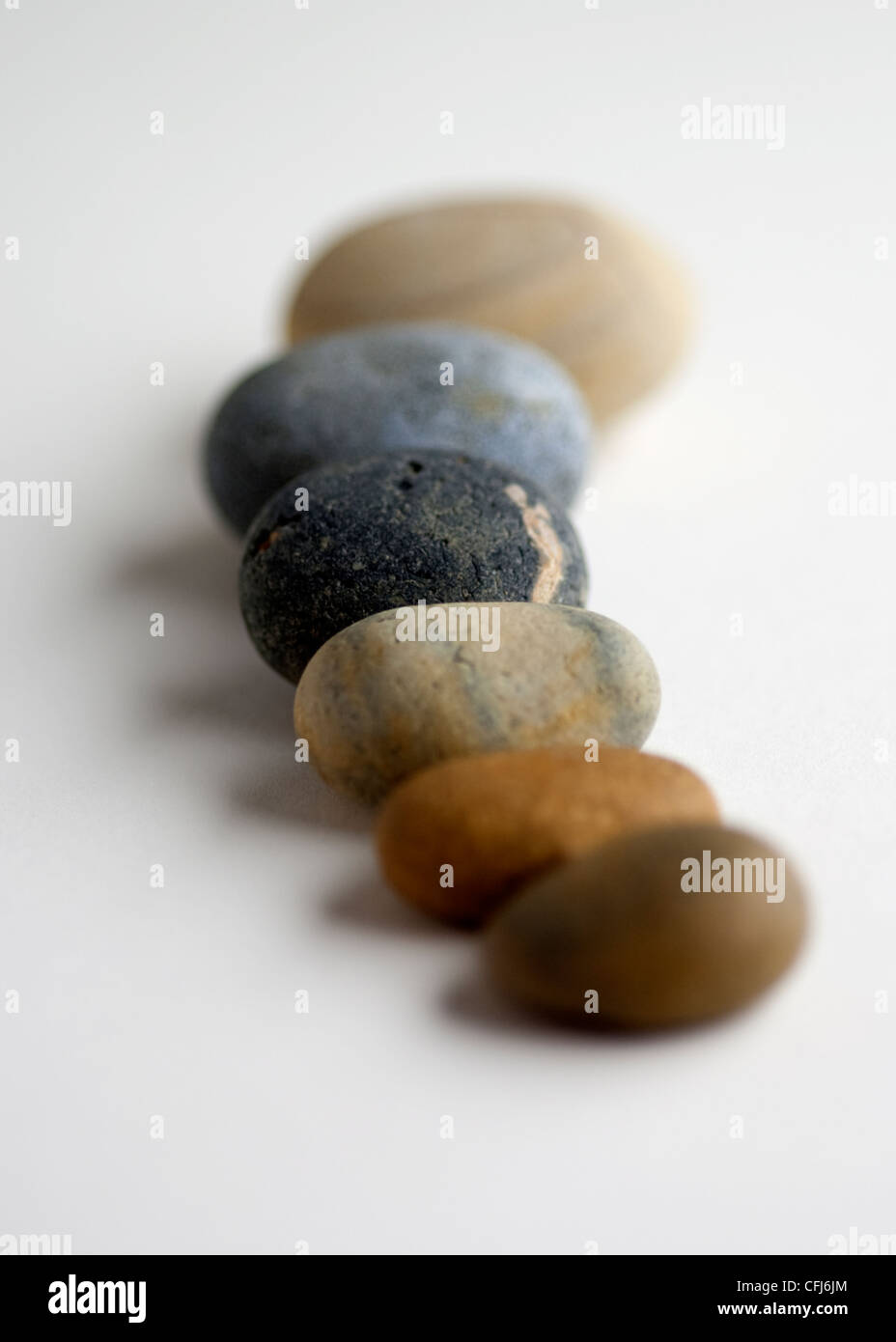 Close up macro study of a row of different coloured pebbles. Shallow ...
