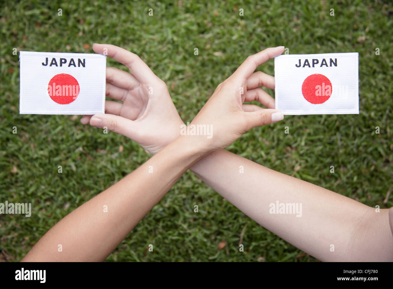 Hands holding Japanese flags Stock Photo - Alamy