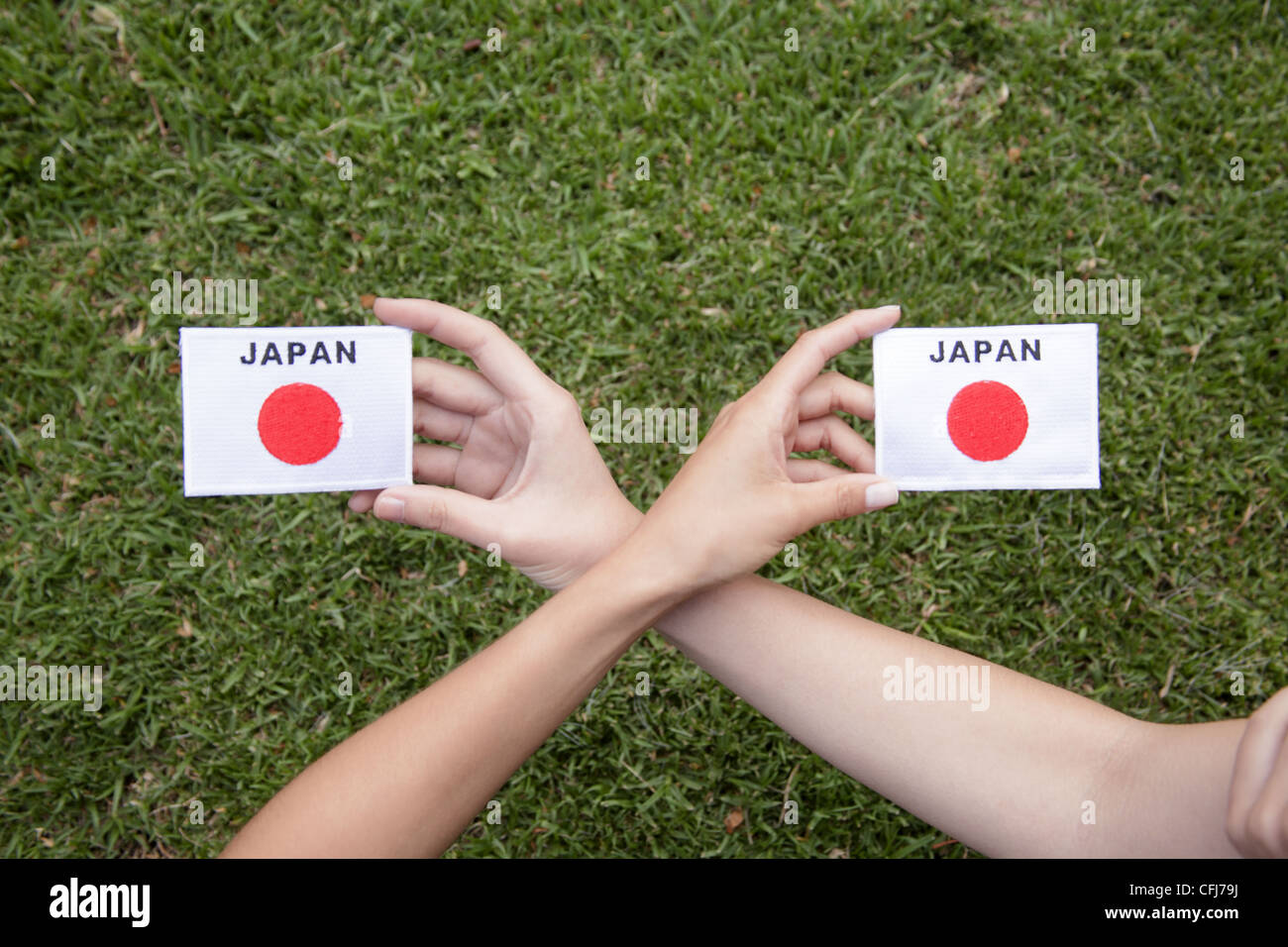 Hands holding Japanese flags Stock Photo - Alamy