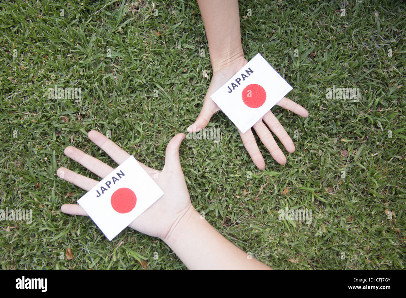 Hands holding Japanese flags Stock Photo - Alamy