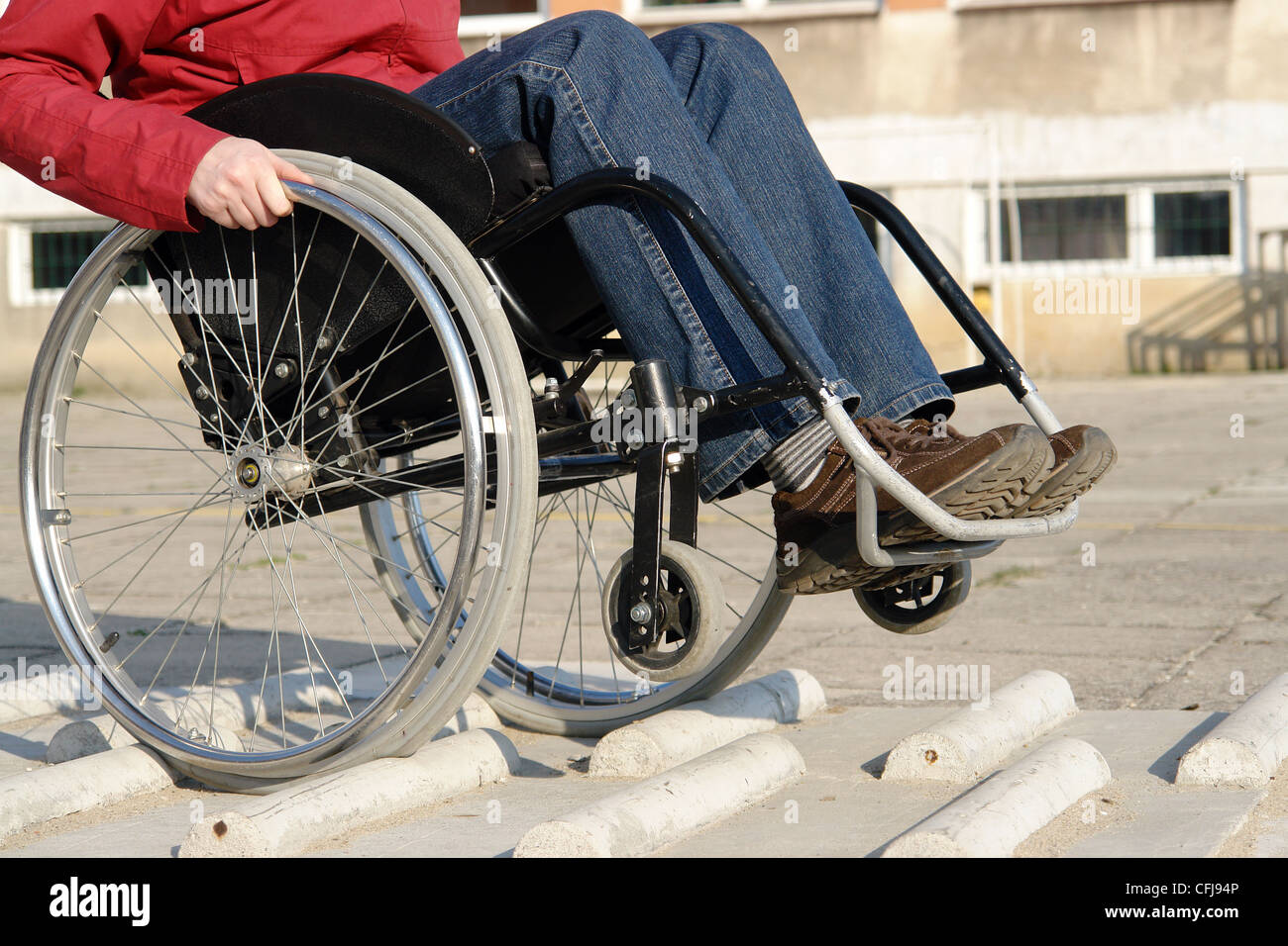 Closeup of handicapped woman practicing wheelchair riding over obstacle ...