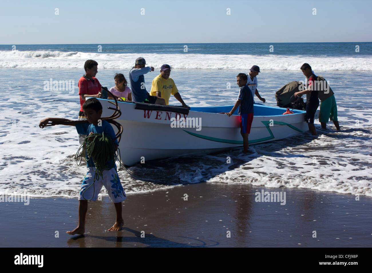 Canoe Just getting out of the Ocean Stock Photo - Alamy
