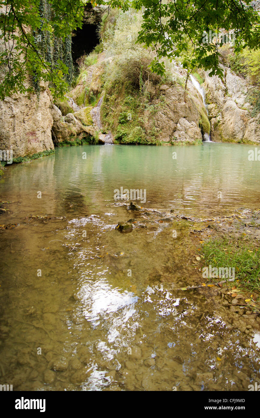 Peaceful lake under a waterfall Stock Photo - Alamy