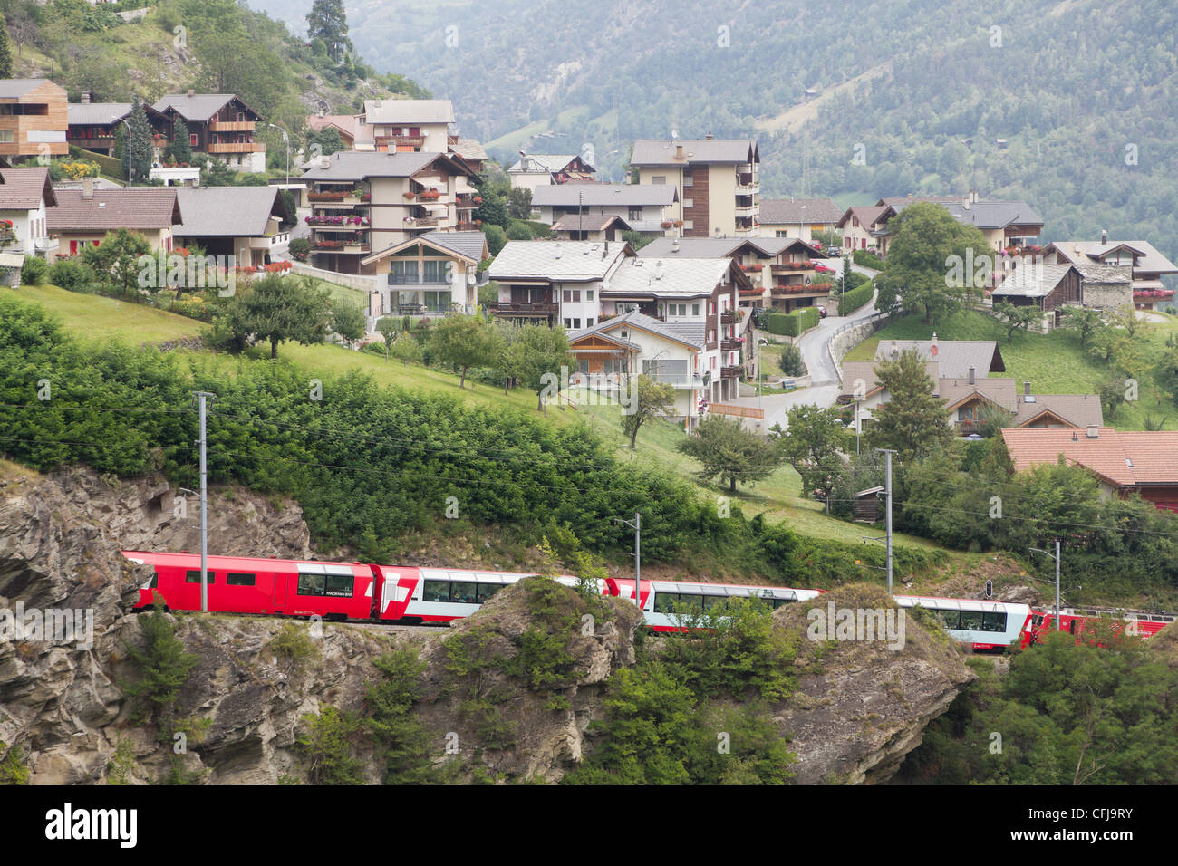 Glacier express train passes village, Switzerland Stock Photo - Alamy