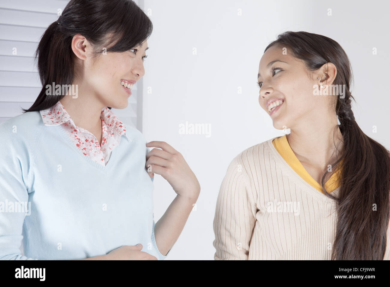 Young women talking Stock Photo - Alamy
