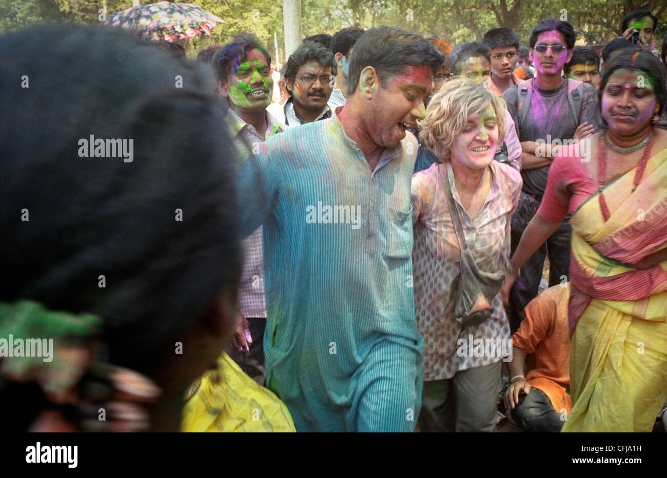 Dancing people at the celebration of Holi festival (colors festival or ...