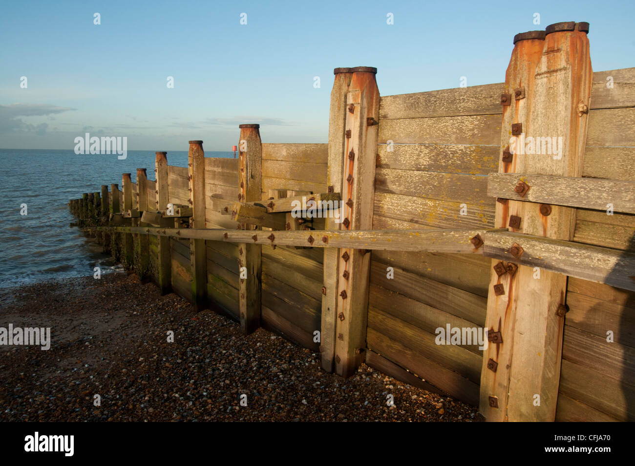 Breakwater wooden sea defenses coastline stone beach Stock Photo - Alamy