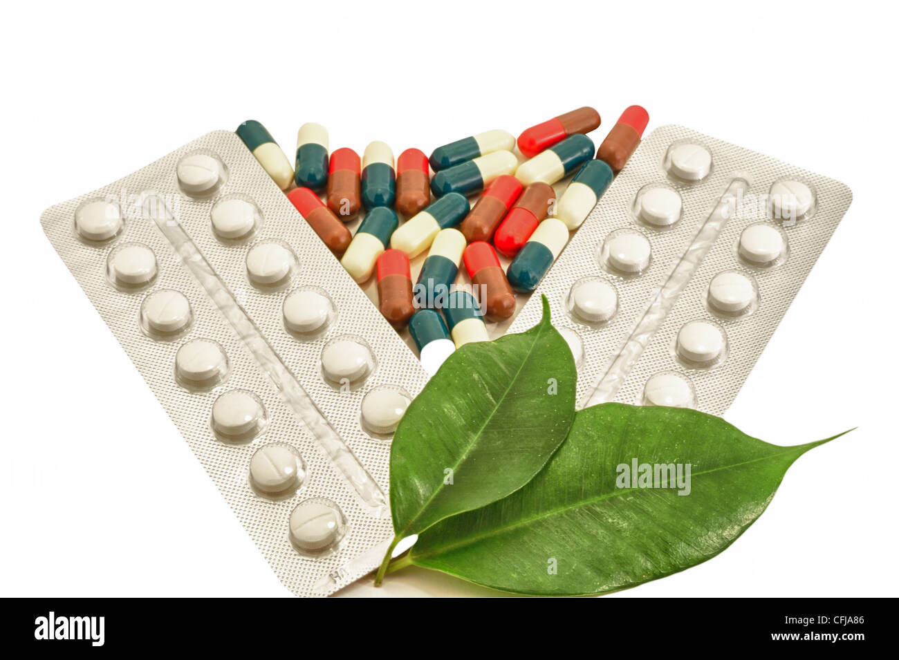 Pills and Capsules medical Bio with green leaf Stock Photo - Alamy