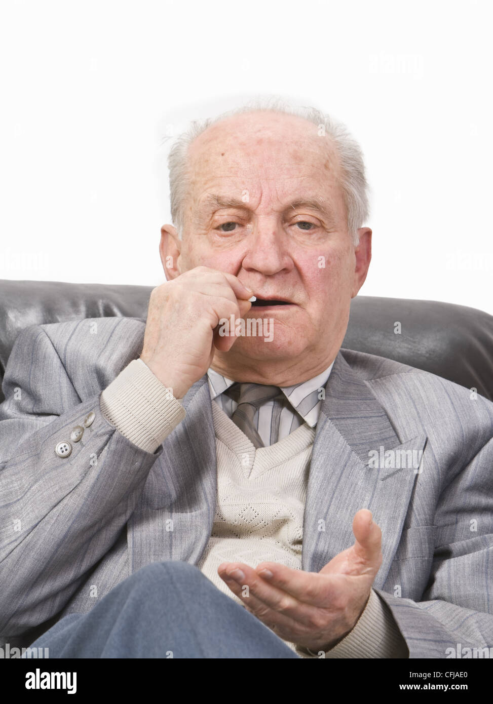 Portrait of a senior man taking his medication Stock Photo - Alamy