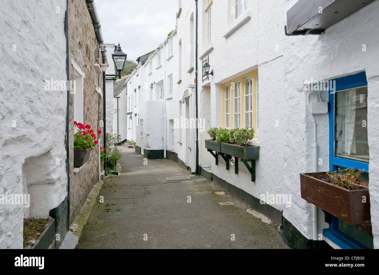 Narrow winding street in fishing village of Polperro, Cornwall UK Stock ...