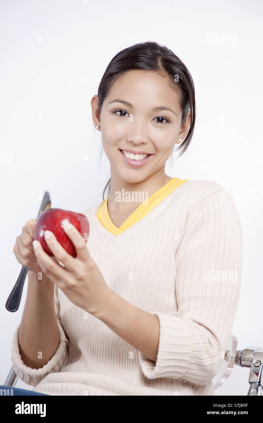 Young woman peeling an apple Stock Photo - Alamy