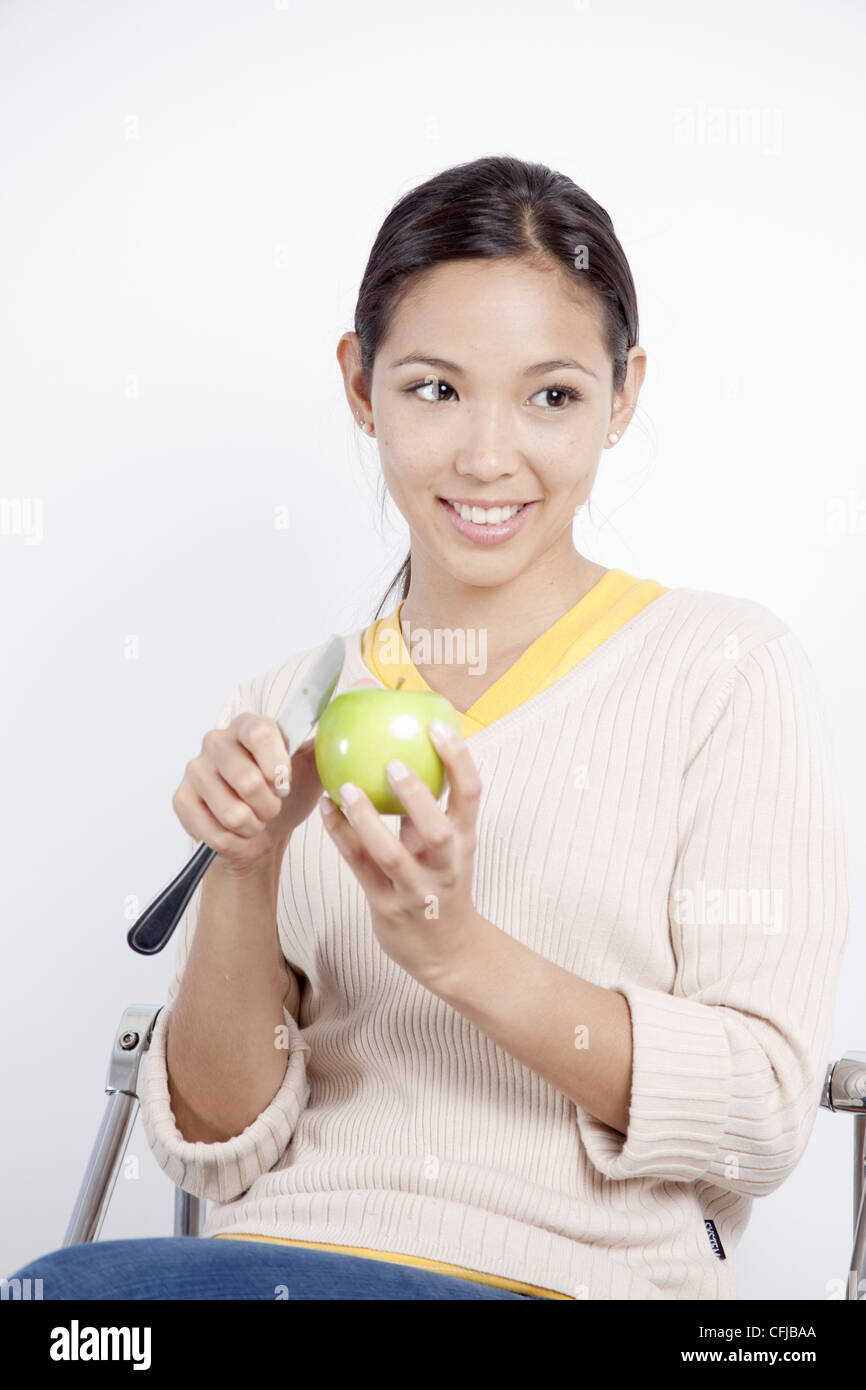 Young woman peeling an apple Stock Photo - Alamy