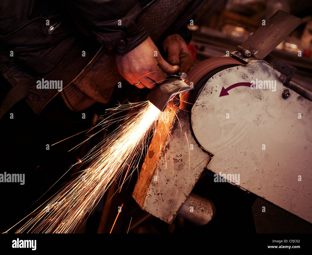 Worker grinding a metal plate Stock Photo - Alamy