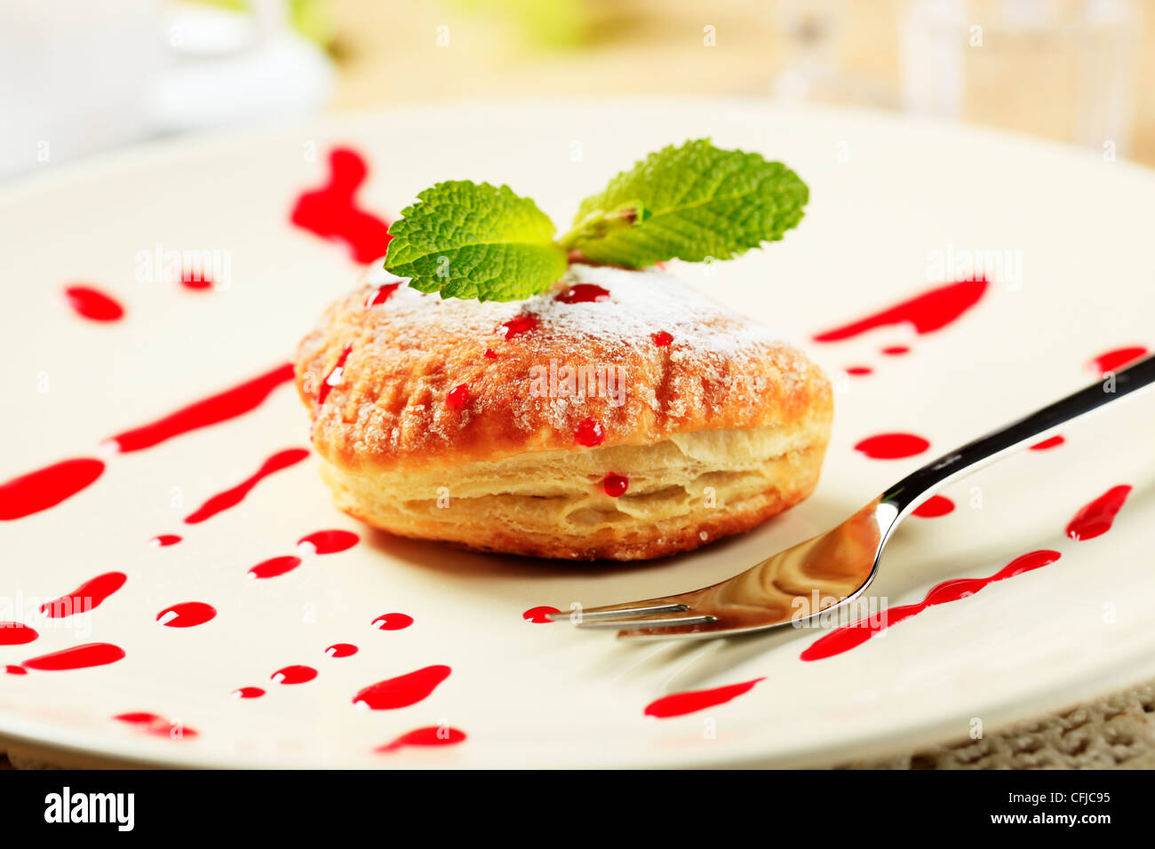 Jam filled donut powdered with icing sugar Stock Photo - Alamy