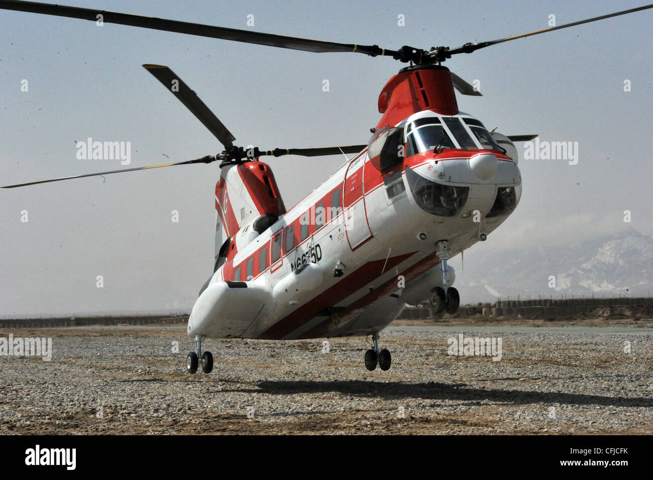 A CH-47 Chinook helicopter arrives to pick up and drop off personnel at ...