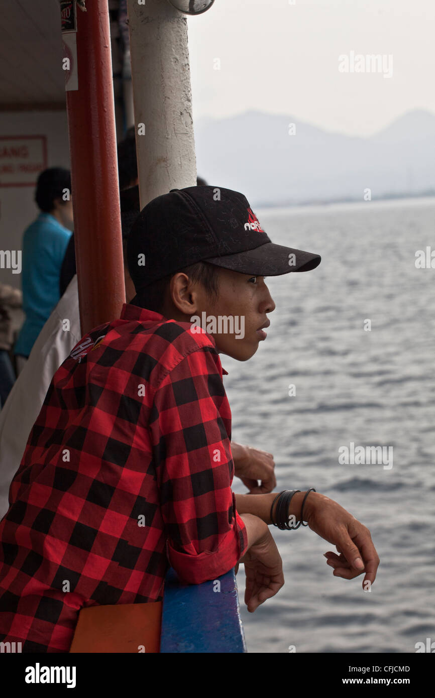 Boy looking through the strait of Bali, Java, Bali, South Pacific ...