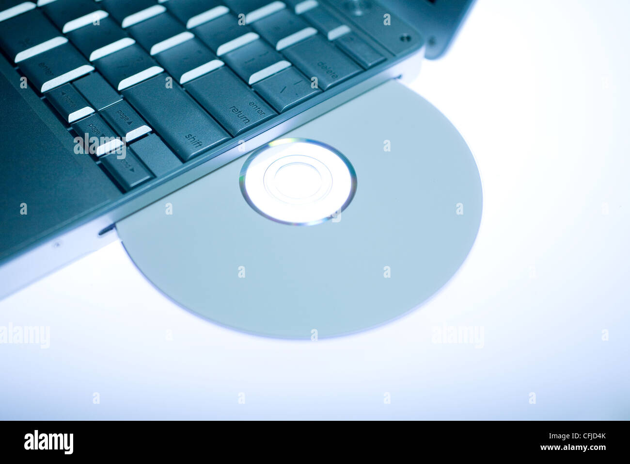 The laptop is loaded with a DVD drive on a white background Stock Photo ...