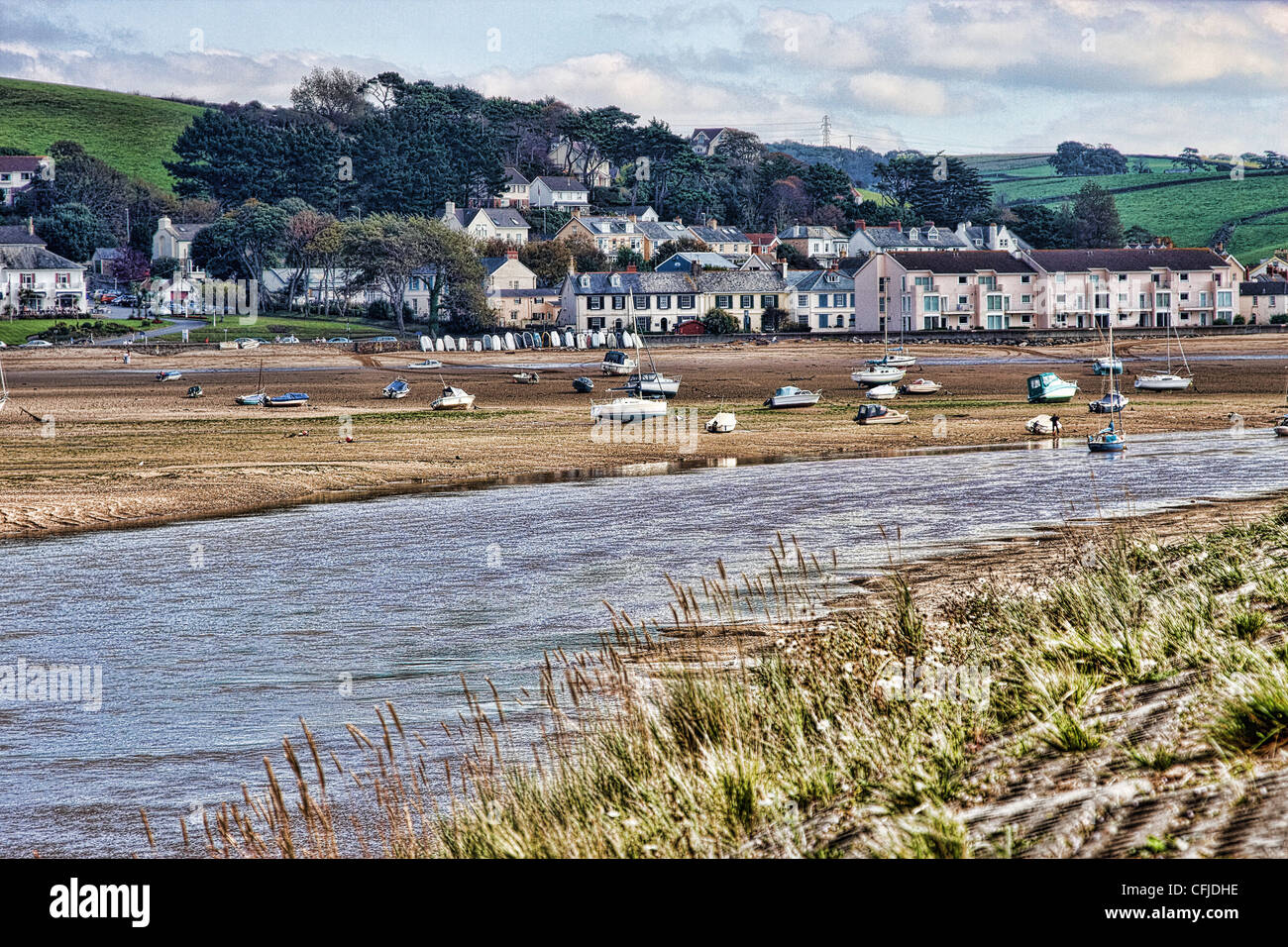 A small village near an estuary with boats moored on dry land Stock ...