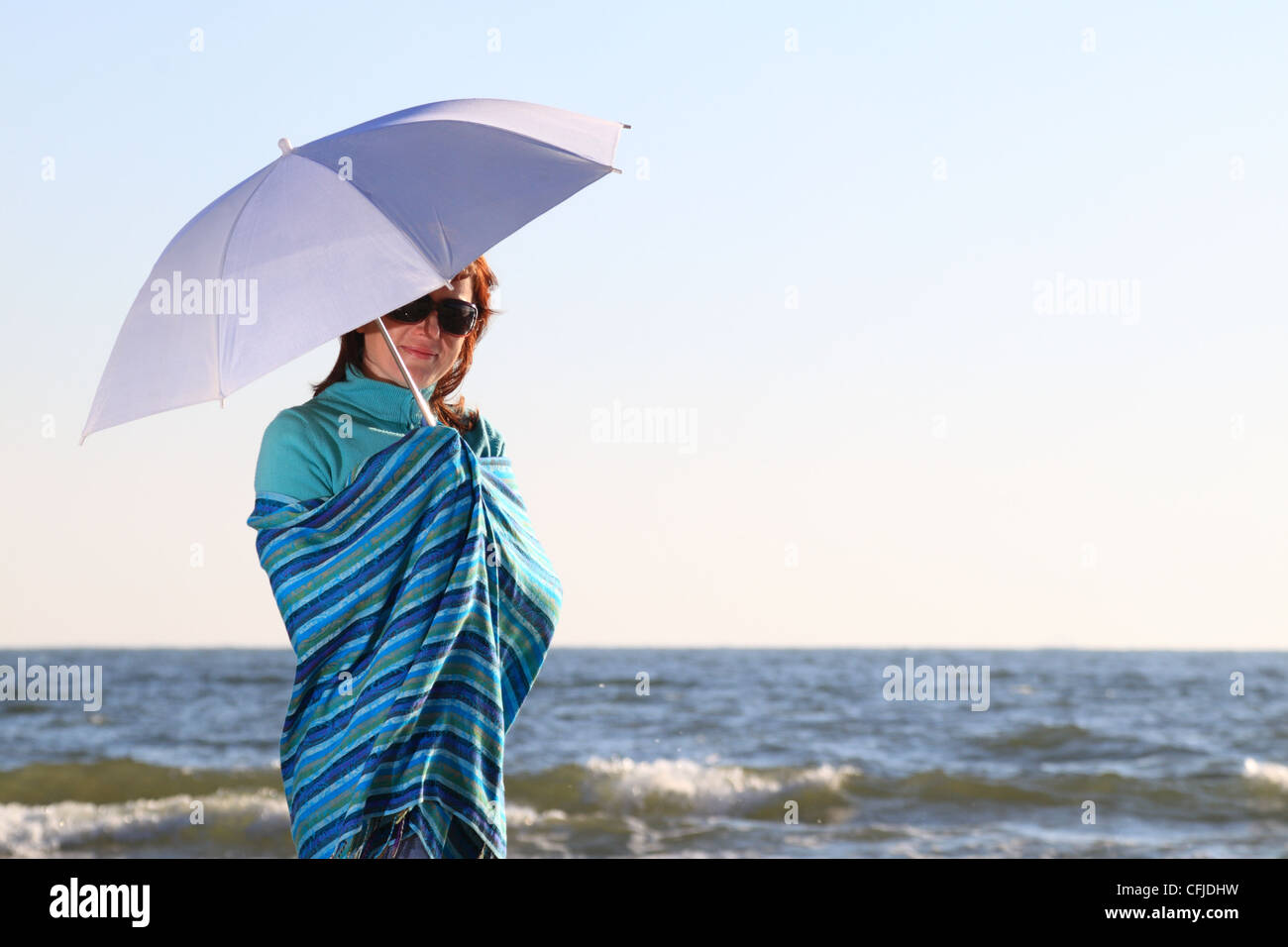 blue woman and parasol at sea shore Stock Photo - Alamy