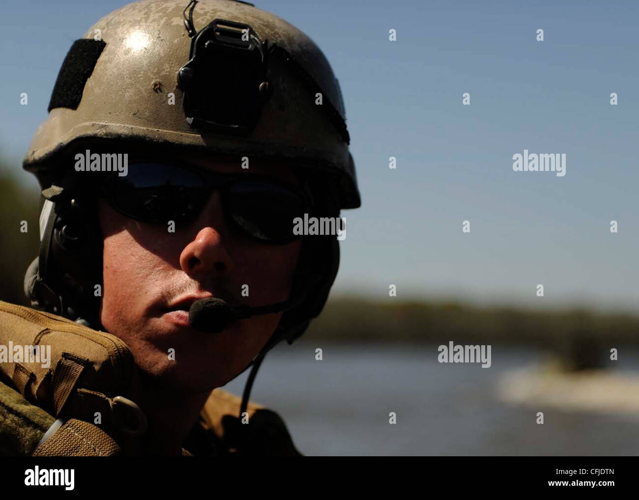 A U.S. Navy boat gunner loads a 245 machine gun during Emerald Warrior ...