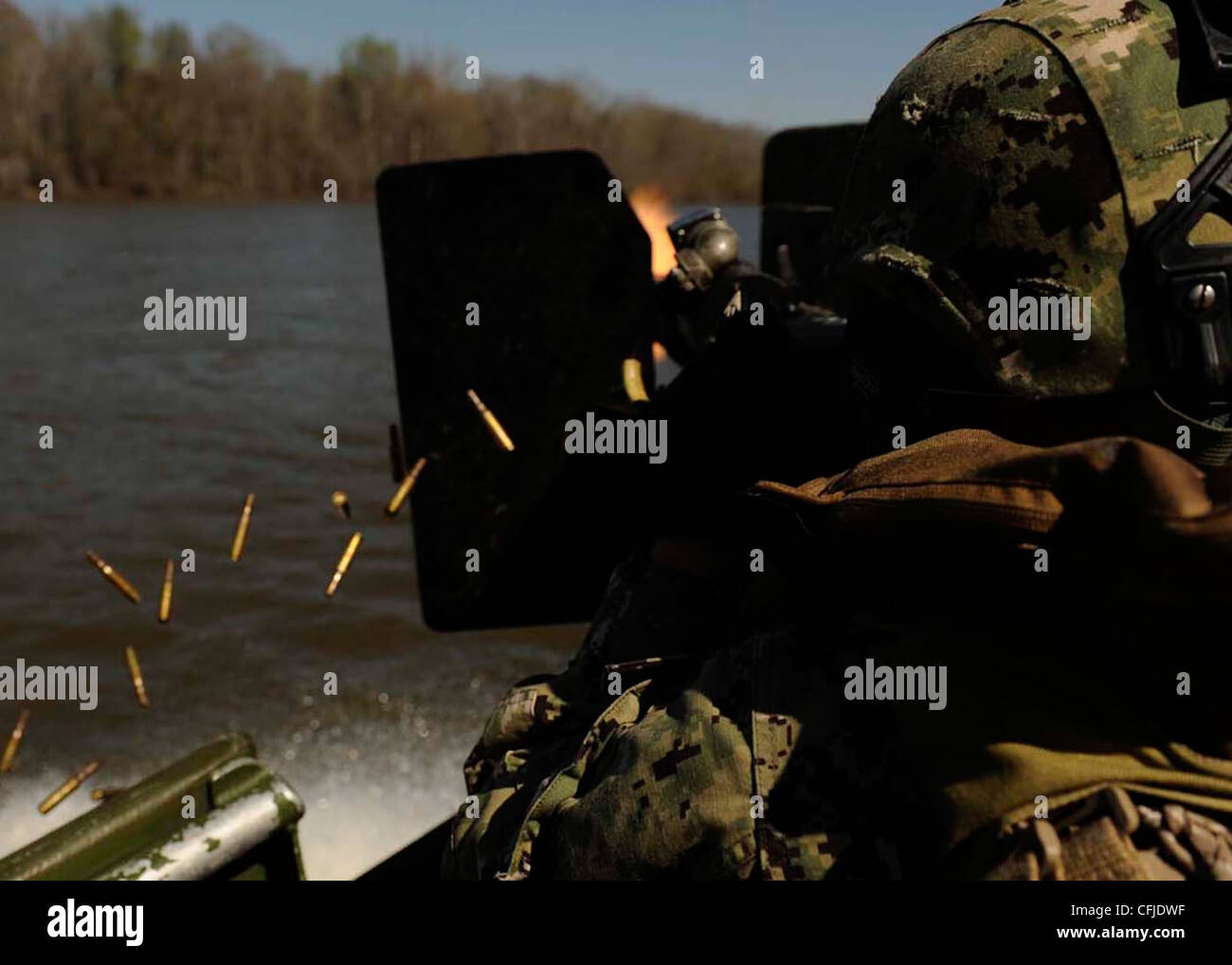A U.S. Navy boat gunner returns fire during Emerald Warrior ...