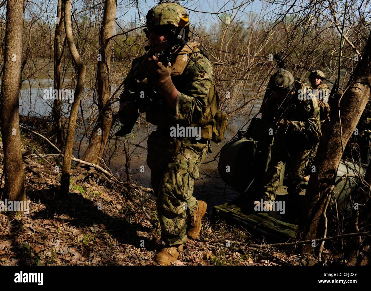 U.S. Navy Riverine security team members prepare to set a perimeter ...