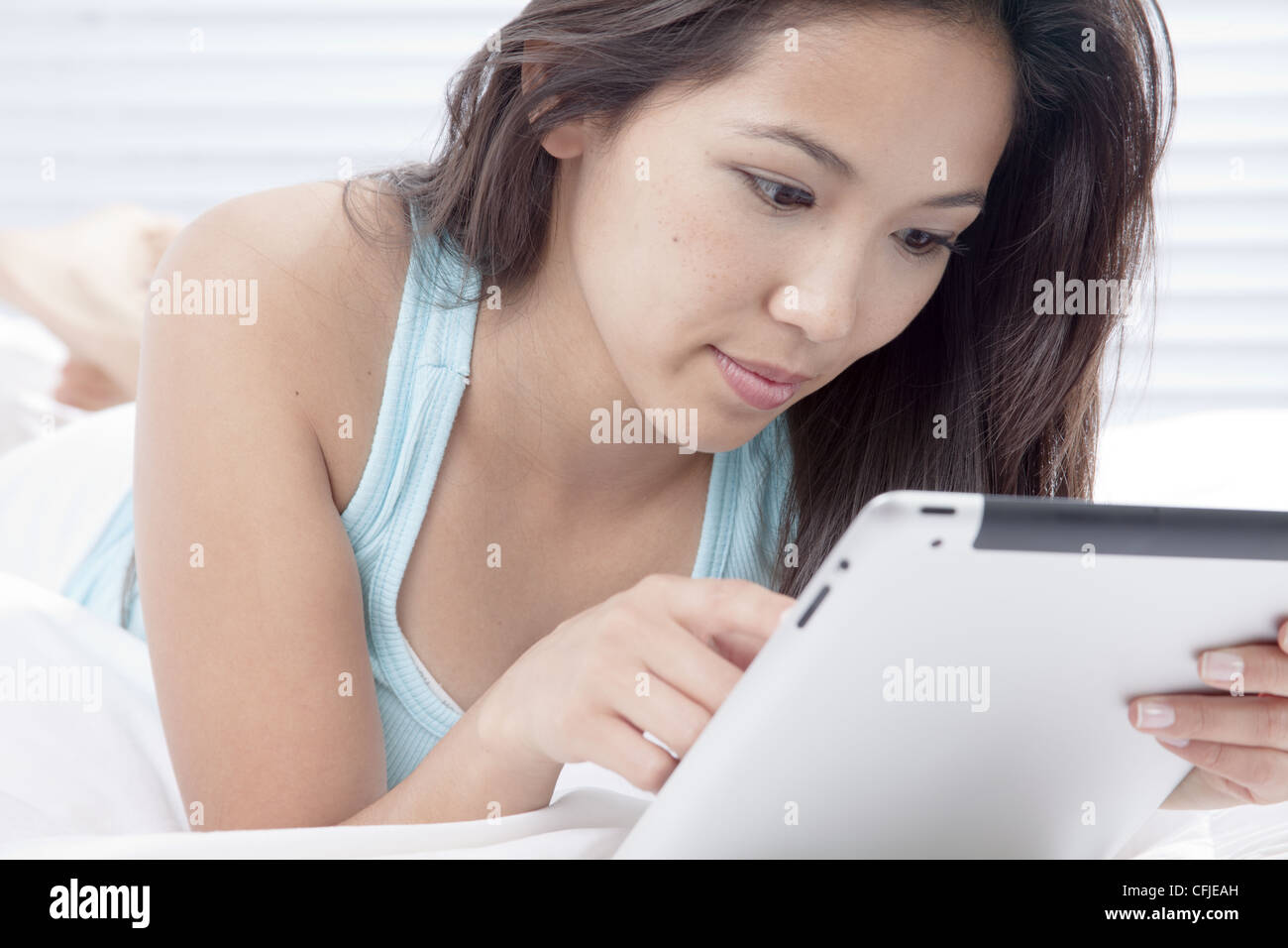 Young woman using tablet PC Stock Photo - Alamy