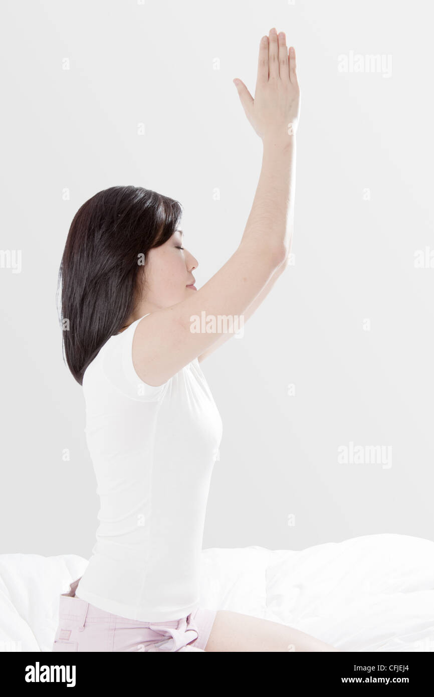 Young woman with closed eyes pressing hands together Stock Photo - Alamy