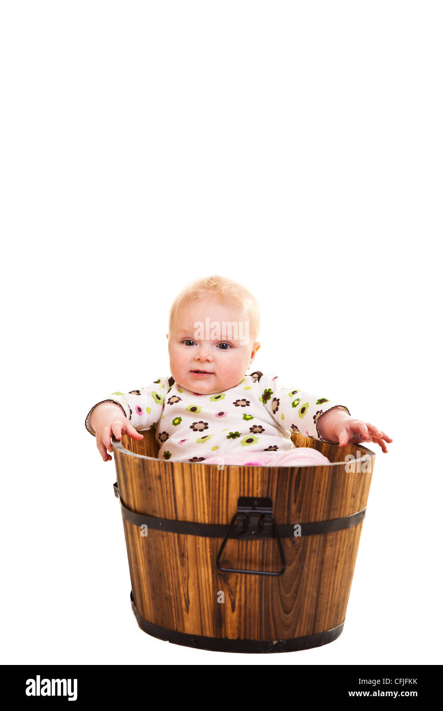 Infant sitting in wooden bucket Stock Photo - Alamy