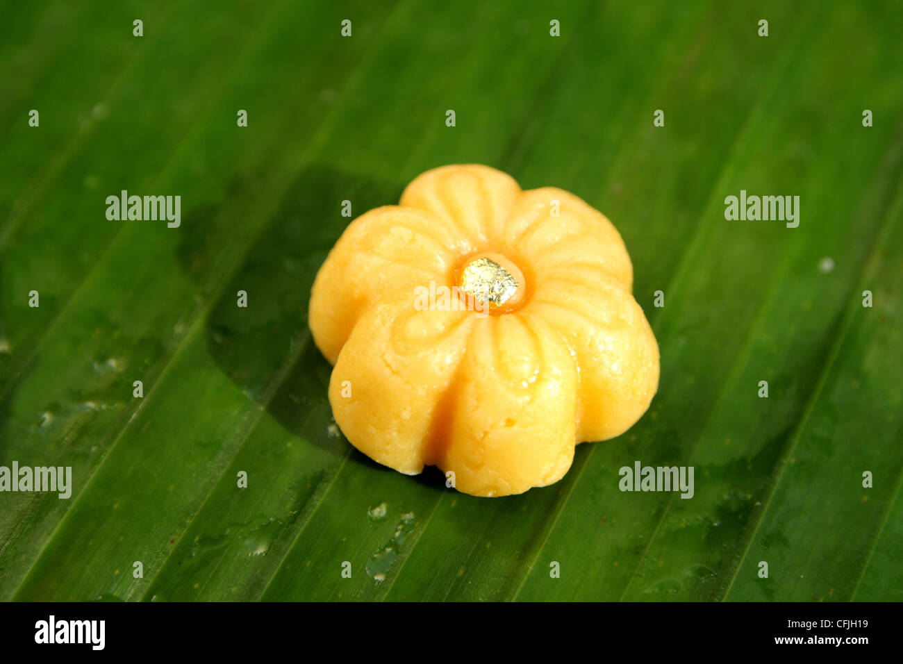 Egg yolks dumpling topped with an edible gold leaf hi-res stock ...