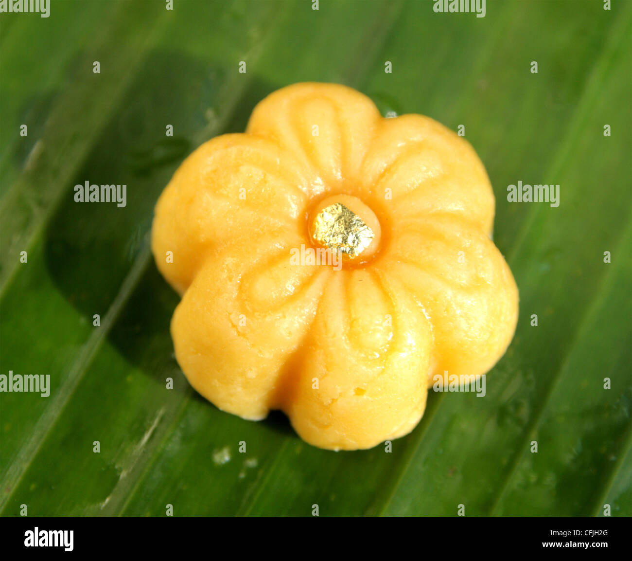 Egg yolks dumpling topped with an edible gold leaf hi-res stock ...