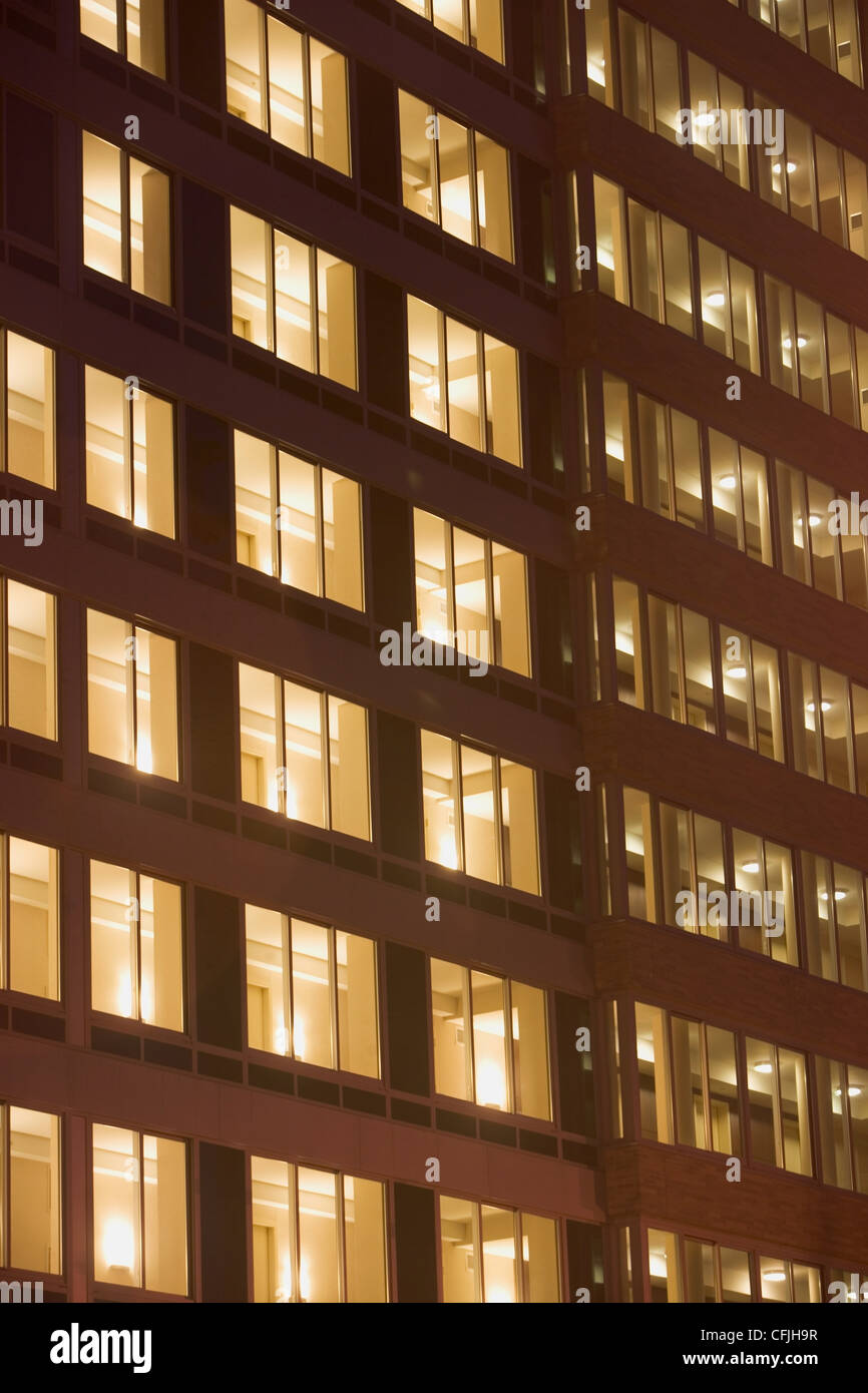 Illuminated windows in office building Stock Photo - Alamy
