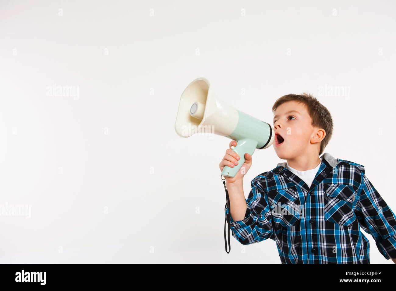 Boy shouting through megaphone Stock Photo - Alamy