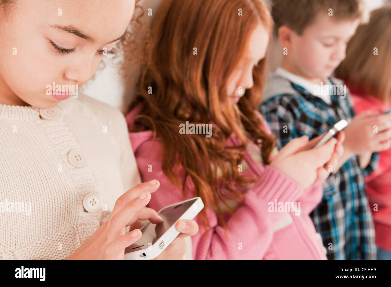 Children looking at smartphones Stock Photo - Alamy