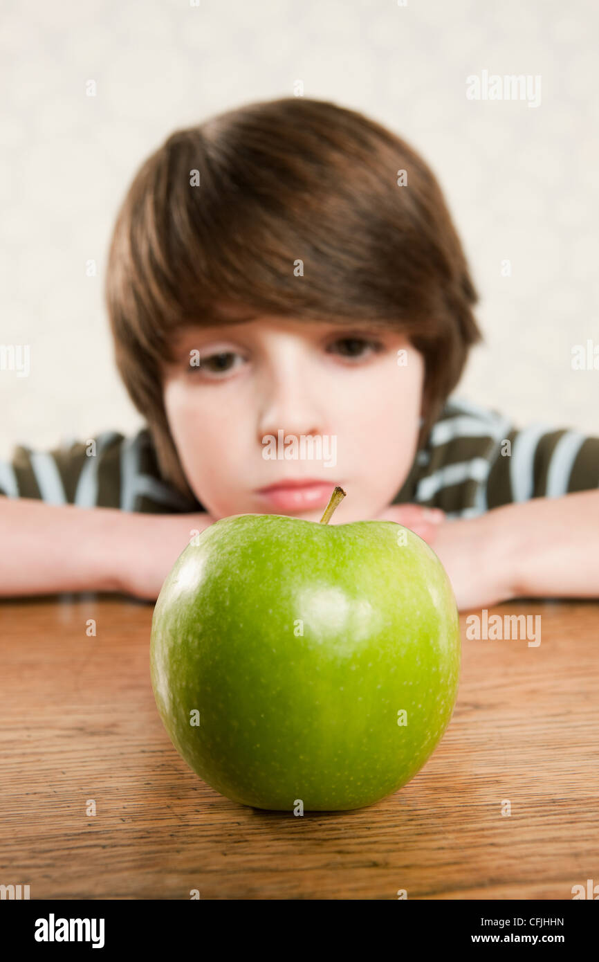 Boy staring at an apple Stock Photo - Alamy