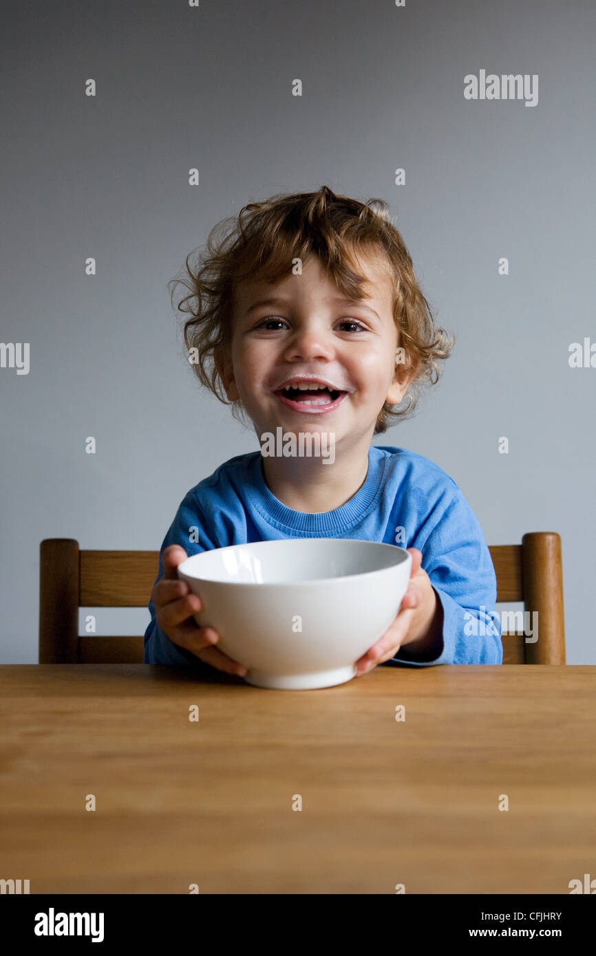 Happy little boy with a bowl Stock Photo - Alamy