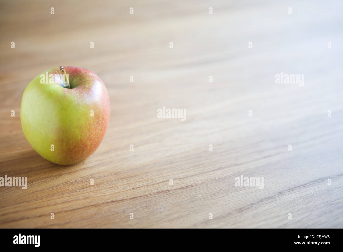 Apple on a table Stock Photo - Alamy