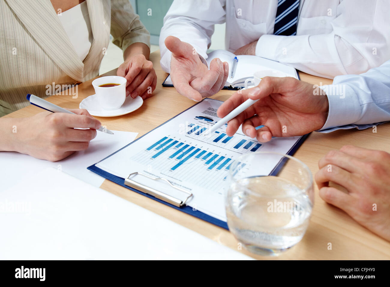 Close-up of human hands during discussion of business documents at ...