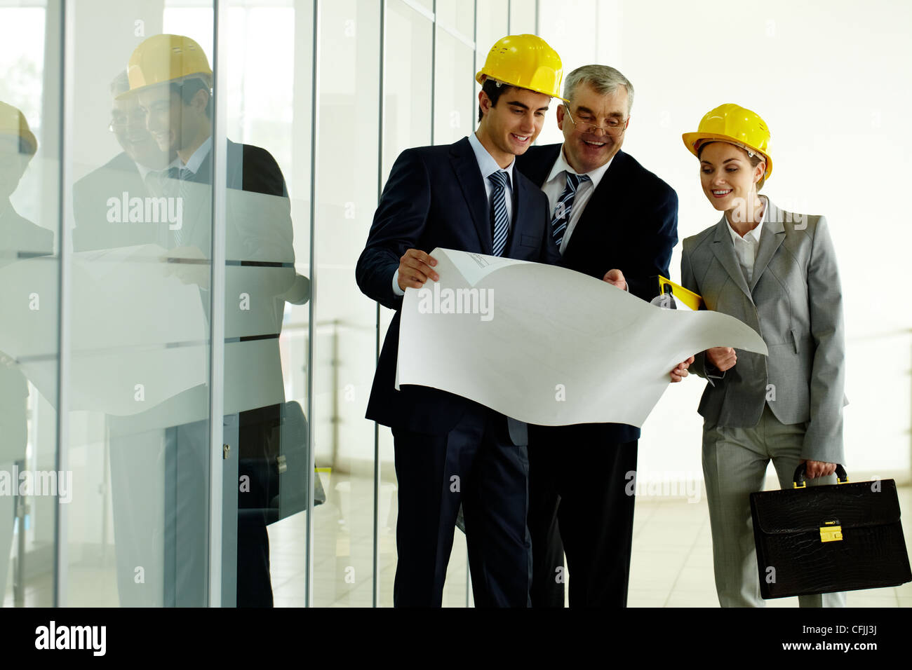 Three architects standing in office building and planning work Stock ...