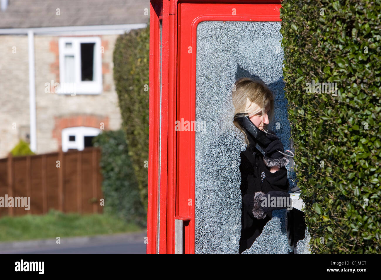 Smashed glass of a vandalised BT red phone box Stock Photo - Alamy