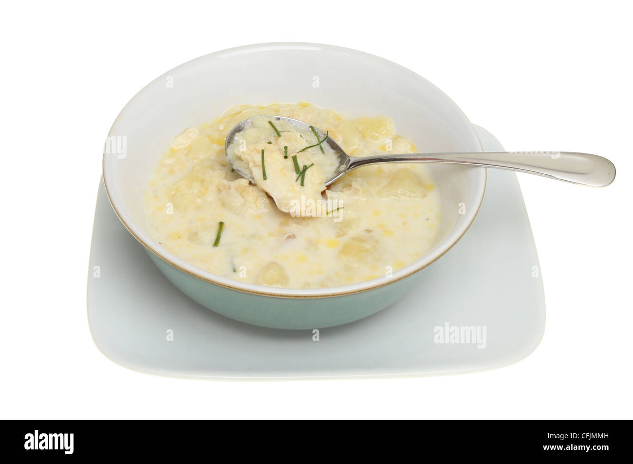 Cullen skink, fish soup in a bowl with a spoon on a plate isolated ...
