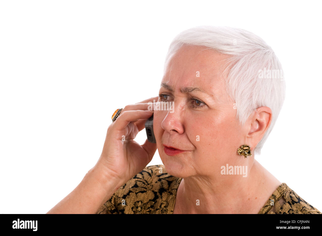 Worried senior woman talking on the phone, isolated on white background ...