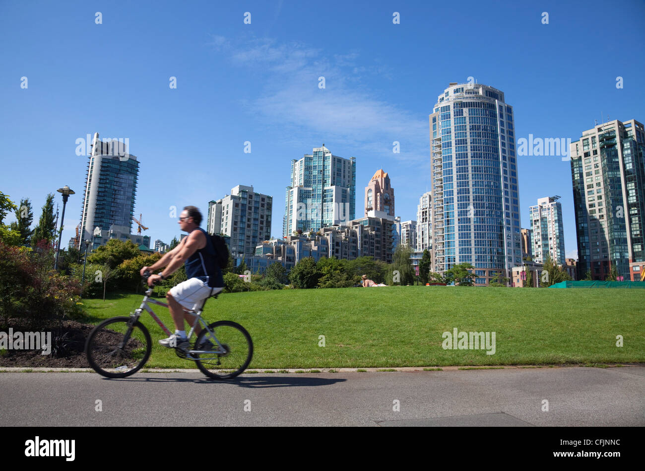 Cyclist passing apartment blocks, False Creek, Vancouver, British ...