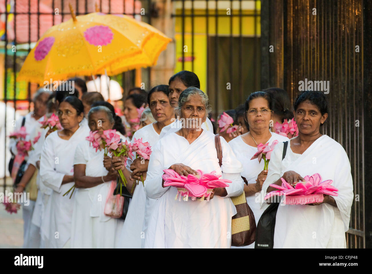 Procession of female Buddhist devotees with offerings at the sacred ...