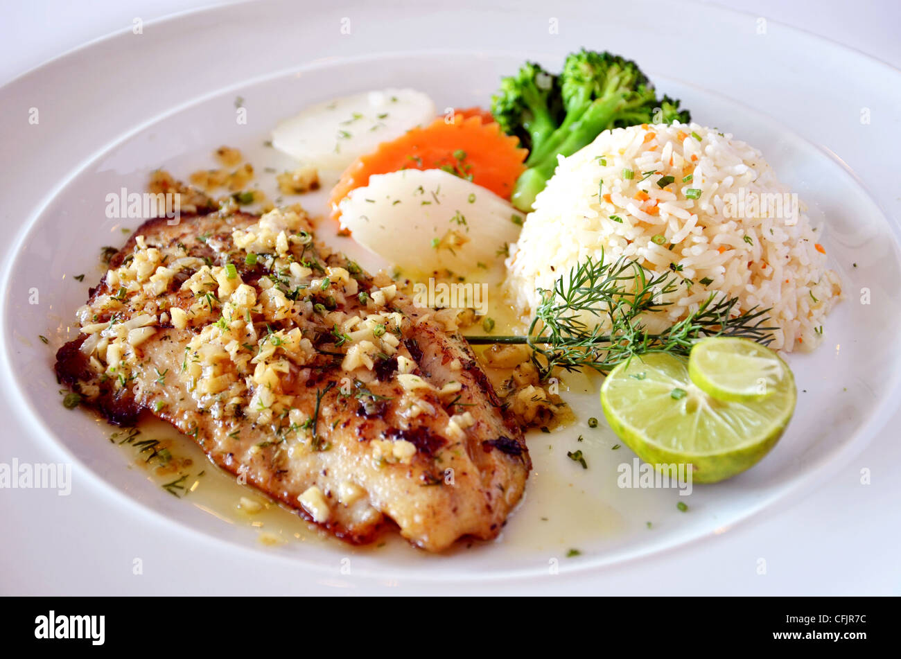 roasted fish served with fried rice Stock Photo - Alamy