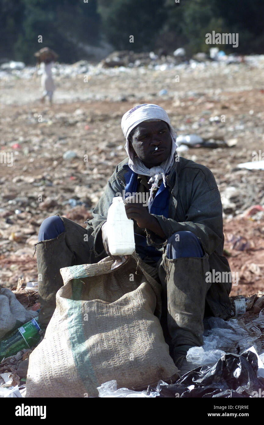 Squatter community living in squalor near a municipal dumping site in ...