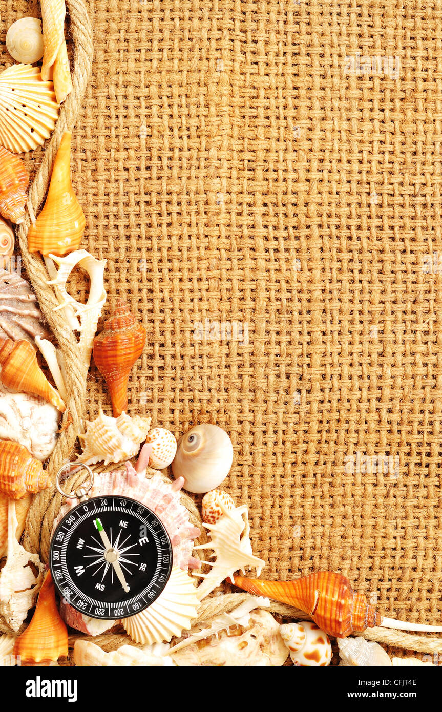 compass on seashell and rope frame on sack Stock Photo - Alamy