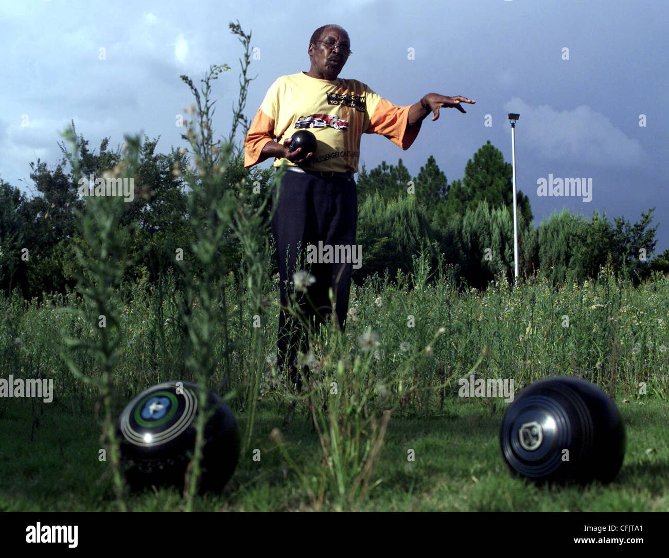 Elliot Mashego of the Dube bowling Club in Soweto stands in the peach ...