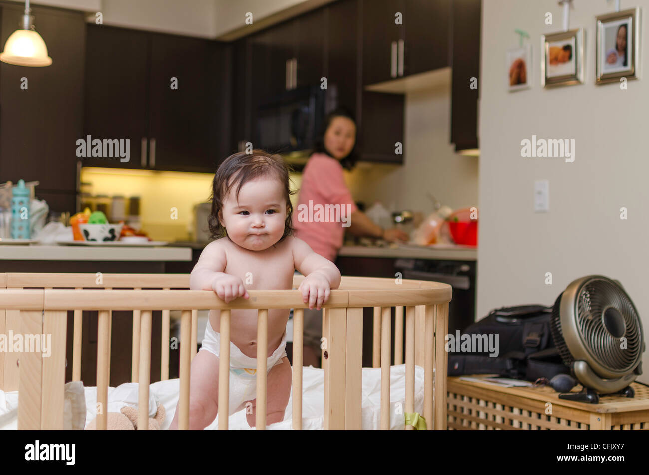 Cute baby girl in a crib. Mixed ethnicity (Asian, Caucasian Stock Photo ...